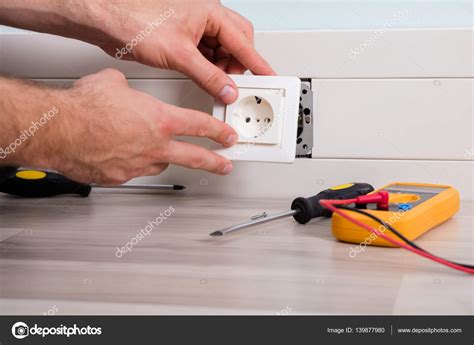 Person Installing Socket On Wall Stock Photo AndreyPopov
