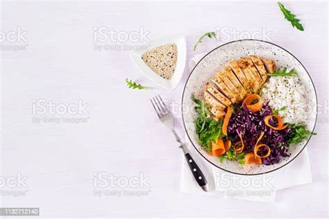 건강 한 샐러드 치킨 필 레 쌀 붉은 양배추 당근 신선한 양상추 샐러드와 참 깨와 부처님 그릇 접시 건강 한 균형 잡힌 식사