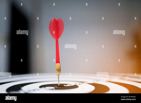 Red Dart Arrow Hitting In The Target Center Of Dartboard Stock Photo Alamy