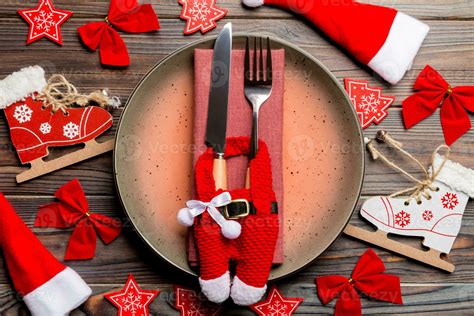 Holiday Composition Of Plate And Flatware Decorated With Santa Hat And