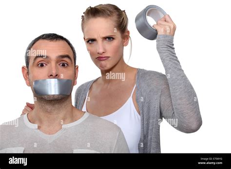 Woman Taping Boyfriends Mouth Closed Stock Photo Alamy