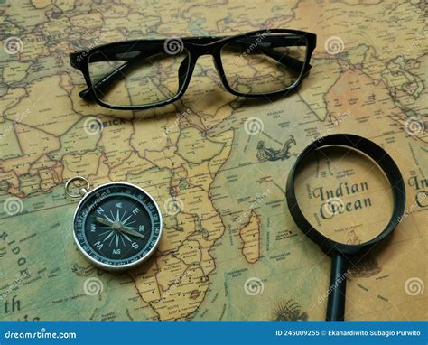 Top View Compass Eye Glasses And Magnifier On World Map Travel And