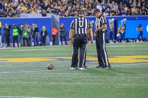 Football Referee And Head Linesman Standing On The Field During A Game Editorial Stock Image