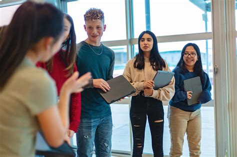 Multiracial Group Of Mixed Gender Teens In Educational Building Walking