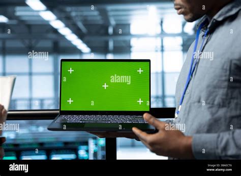 Employees In Data Center Using Isolated Screen Mockup Laptop Integrating Green Technologies It