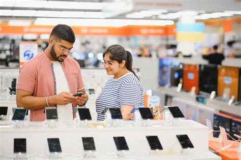 Tech Shopping Device Gadget Concept Happy Young People Buying A New Smartphone In Mobile Shop