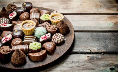 Premium Photo Chocolate Sweets On A Wooden Board