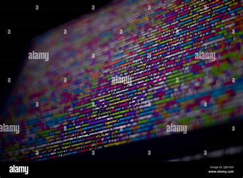 Colorful code background. compressed javascript code on computer screen. Software developer ...