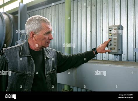 Worker Pushing Button On A Control Panel Of Pumping Station Stock Photo Alamy