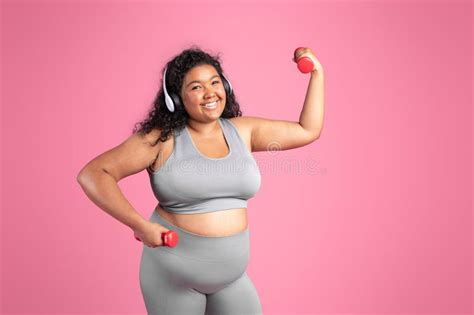 Happy African American Chubby Lady In Sportswear Wireless Headphones