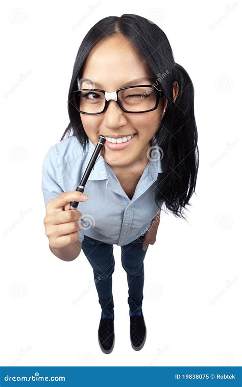 A Smiling Nerdy Asian Girl Biting On A Pencil Royalty Free Stock