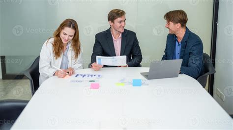 Team Collaborating In A Modern Office Setting During A Business Meeting