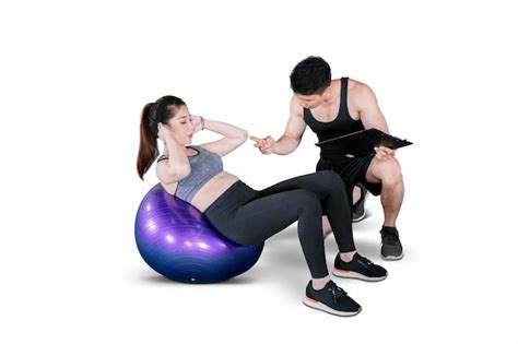 Premium Photo Young Instructor Counting Woman Doing Exercise