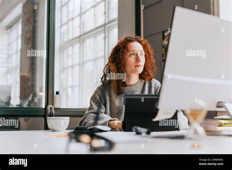 Focused Redhead Businesswoman Working On Desktop Pc At Office Stock Photo Alamy