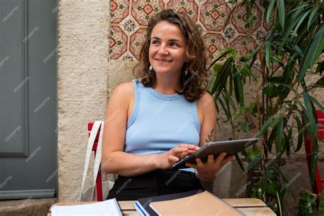 Free Photo Portrait Of Braless Woman Outdoors With Tablet At Cafe
