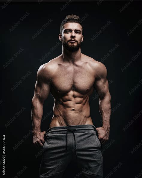 Plakat Slim Muscular Male Model At Black Background Fitness Shirtless