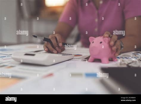Asian Businesswoman Calculating Saving Account Balance With Calculator