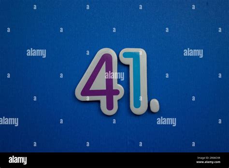 The Number Placed On A Blue Background Photographed From Above Purple And Light Blue In