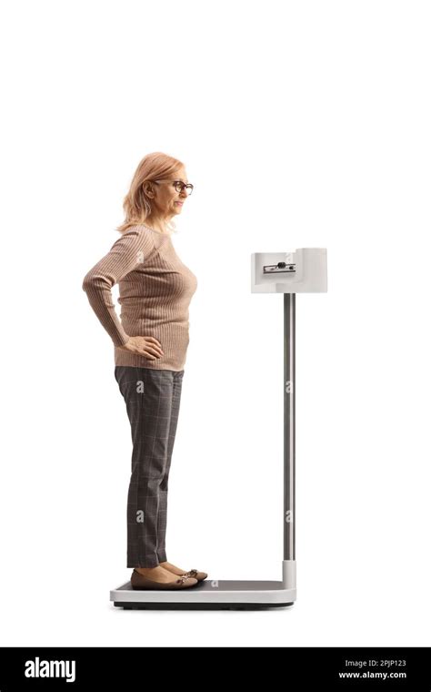 Full Length Profile Shot Of A Woman Checking Her Weight On A