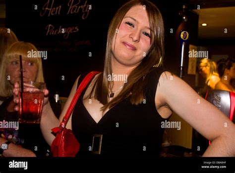 An Attractive Busty Woman Holding A Drink Having Her Photograph Taken Inside A Pub During The