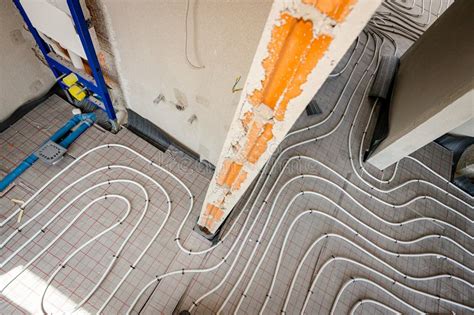 pipe system of floor heating mounted in unfinished washroom stock image