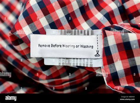 Remove Before Wearing Or Washing RFID Tag On Red Checked Shirt Stock Photo Alamy