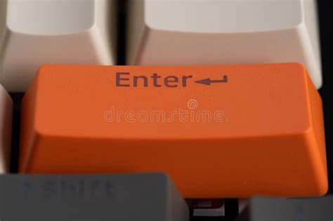 close up of orange computer keyboard key with enter button stock image