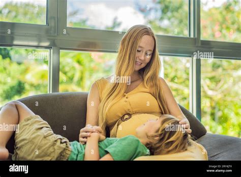 A Heartwarming Moment Pregnant Mother And Her Older Son Sit On The