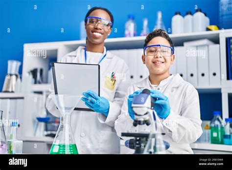 African American Mother And Son Scientists Using Microscope Laboratory Stock Photo Alamy