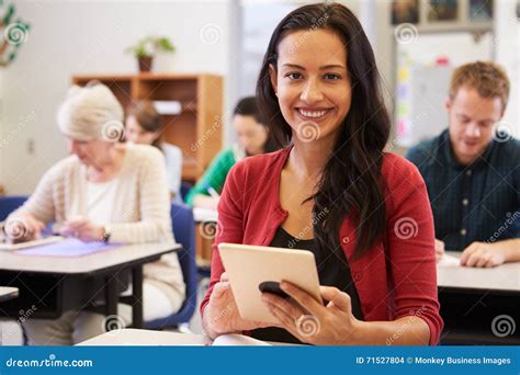 Hispanic Woman With Tablet Computer At An Adult Education Class Stock
