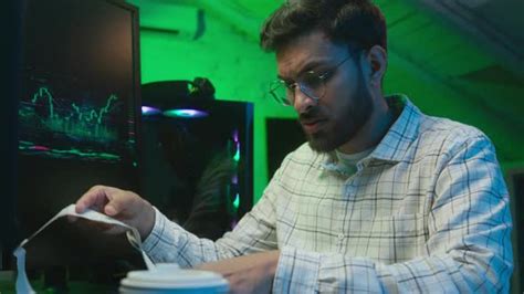 Frustrated Arabian Indian Man Programmer Holding Paper Code Bills Problem Checking Information