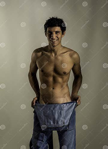 A Stylish Young Man Showcasing His Fit Physique With A Pair Of Jeans
