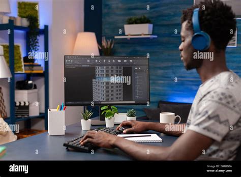 African American Engineer Man With Headphones Analyzing Architecture