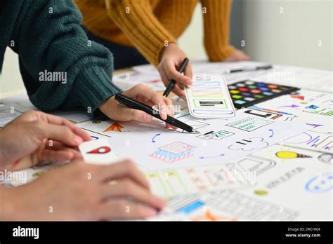 Mobile Application Designers Brainstorming And Discussing New App Features At Co Working Space