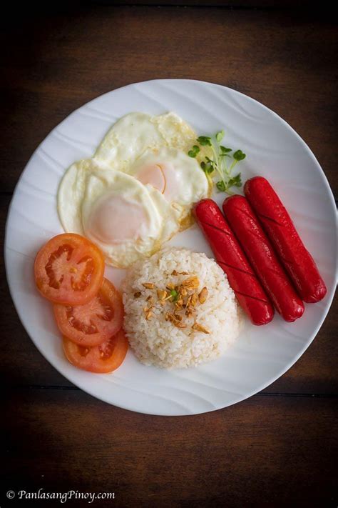 A White Plate Topped With Rice Tomatoes And Eggs