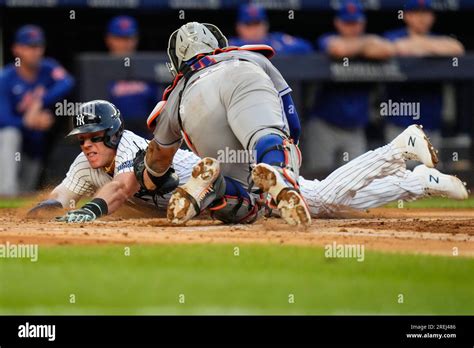 New York Yankees Harrison Bader Slides Past New York Mets Catcher