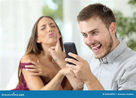 Man With A Smart Phone Ignoring A Sex Proposal Stock Image Image Of