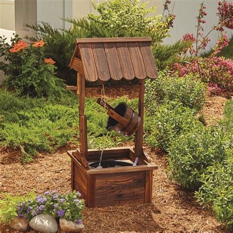 Wooden Water Well In The Middle Of A Garden