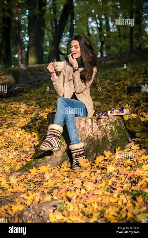 Girl Sitting On Tree Stump Stock Photo Alamy