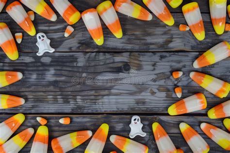 Halloween Candy Corn And Ghost Candies On Rustic Wood Stock