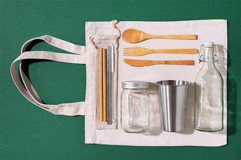 면 가방 유리 항아리 병 금속 컵 마시는 빨대 대나무 칼붙이 및 녹색 배경에 상자 지속 가능한 라이프 스타일 폐기물 제로 플라스틱 무료 쇼핑 개념 가방에 대한 스톡 사진 및