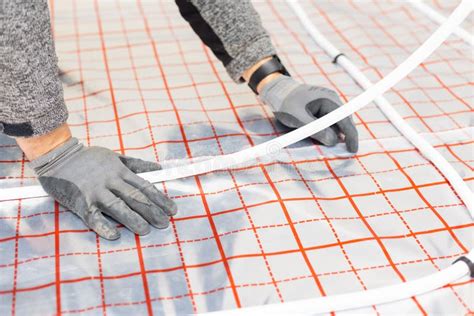 Worker Installing Underfloor Heating System Water Heating On The New Residential House Concept