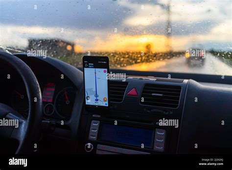 Using Waze Maps Application On Smartphone On Car Dashboard Driver Using Maps App For Showing