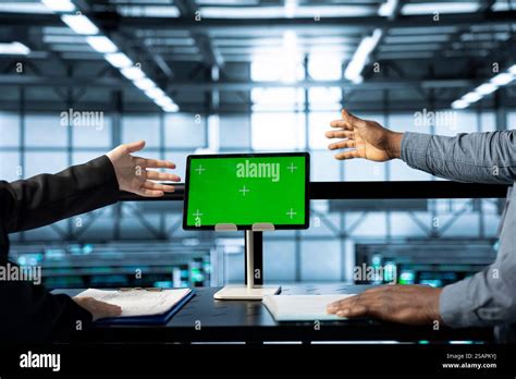 Technicians In Data Center Using Chroma Key Green Screen Tablet