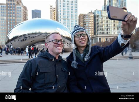 Chicago Usa 17 December 2018 A Couple Takes A Selfie As Tourists Visit Cloud Gate Known