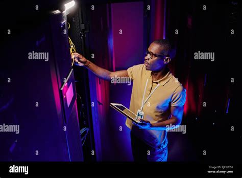 high angle shot of system administrator setting up server network in