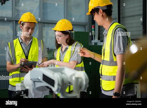 engineer and technician discussing the robotic arm in factory about