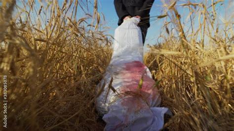 Anonymous Murderer Dragging Bleeding Dead Body In White Bag Through