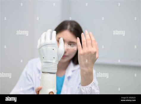 Technician Testing Robotic Bionic Arm At Prosthetic Manufacturing Stock
