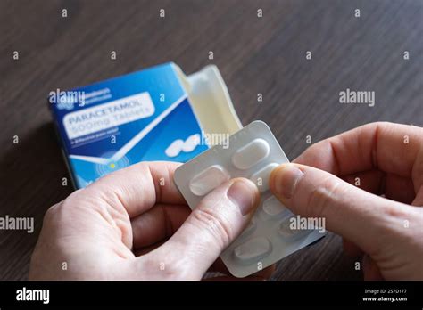 Middle Aged Man Removing A Paracetamol Tablet From A Blister Pack Used